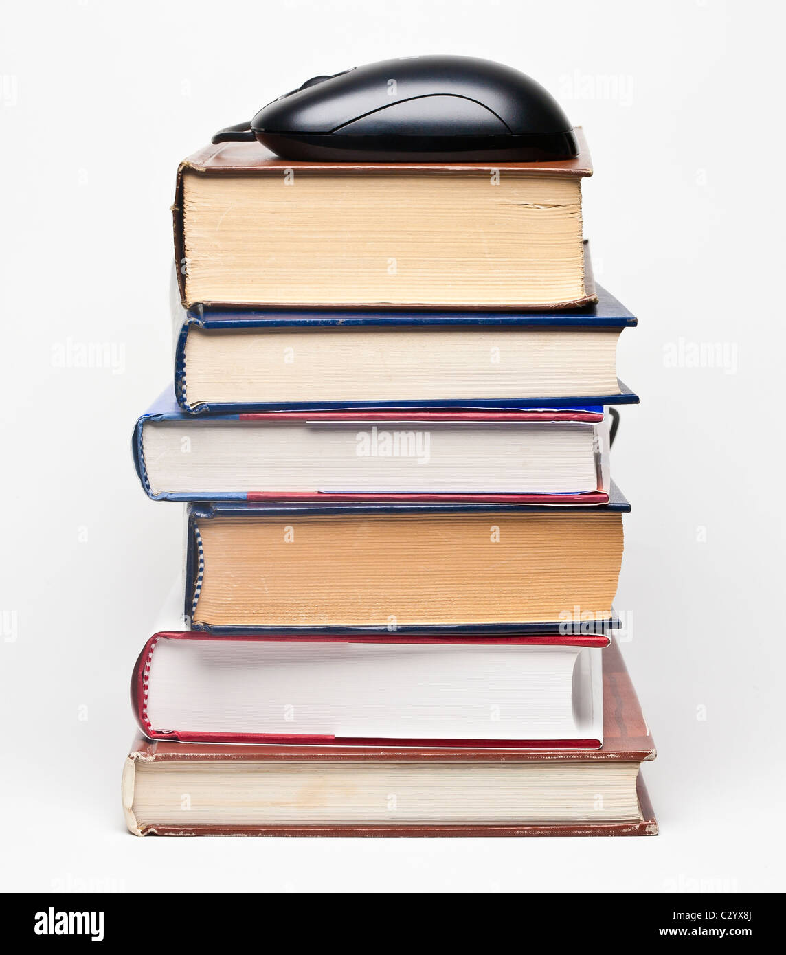 stack of hardcover books and black mouse Stock Photo - Alamy