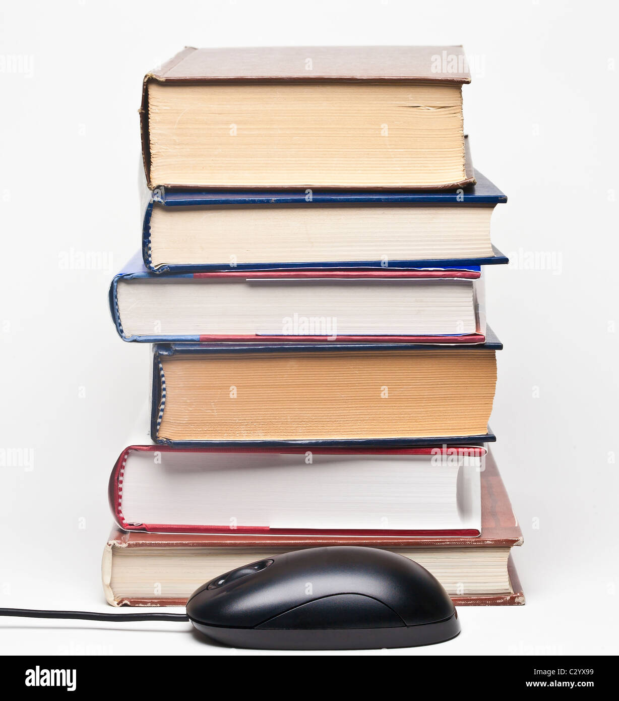 stack of hardcover books and black mouse Stock Photo - Alamy