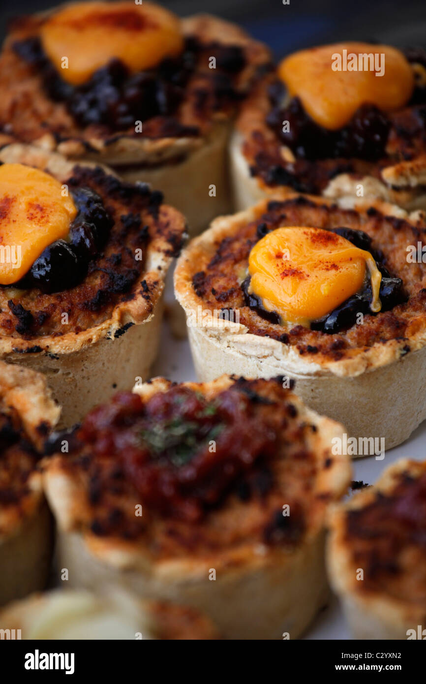 Homemade pork pies with toppings on sale at a farmer's market Stock ...