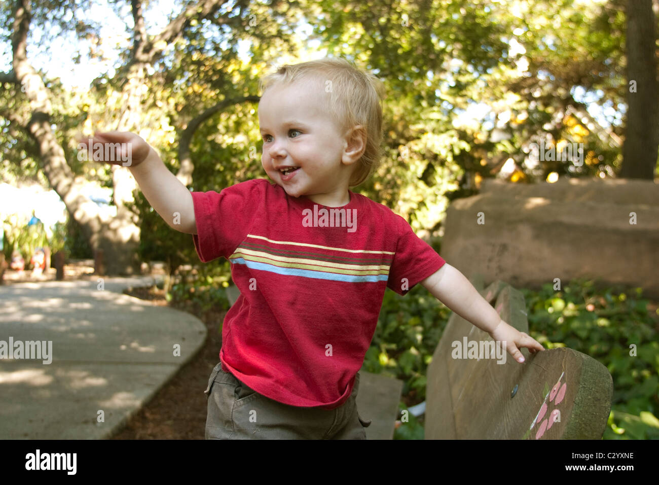 A 3 year old child playing in a park in Oakland, CA Stock Photo - Alamy