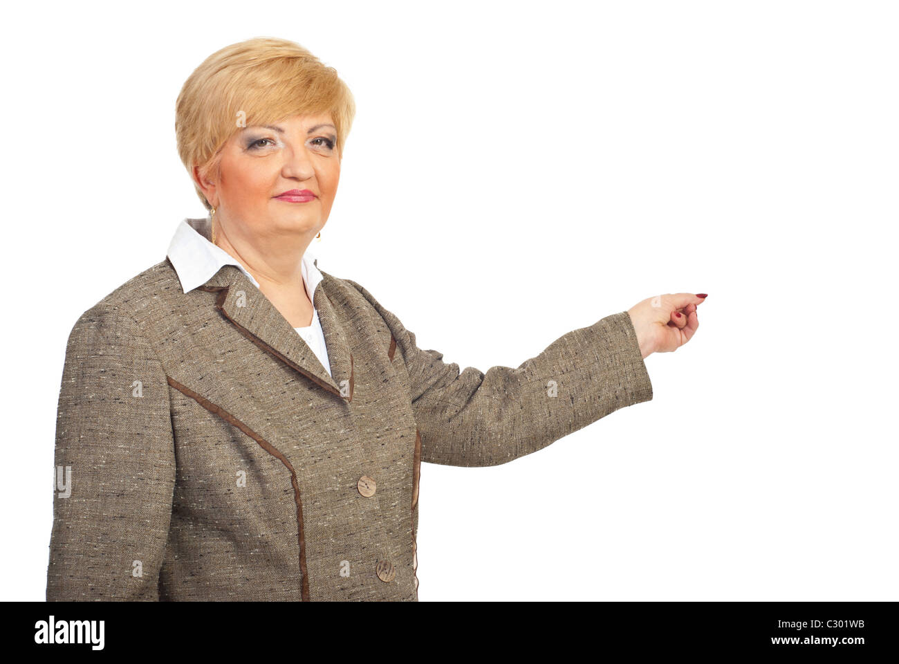 Mature executive woman pointing to white space on background Stock ...