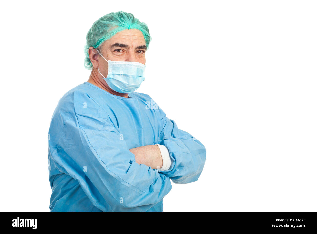 Middle aged surgeon man standing with arms folded and looking camera ...