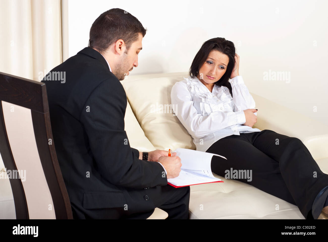 Psychiatrist talking with depressed woman patient and trying to help ...