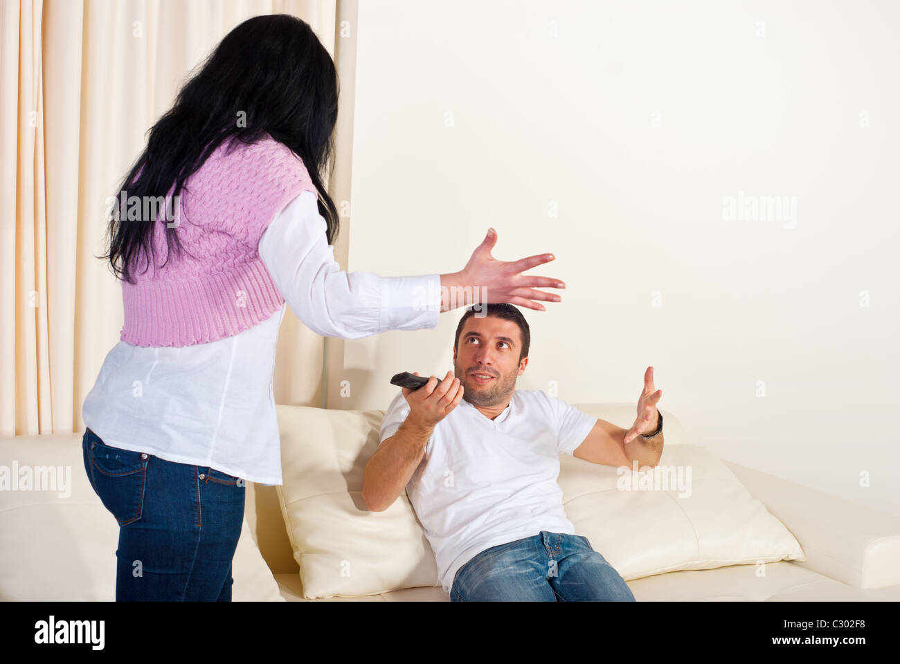 Wife and husband on couch having conflict and arguing home Stock Photo ...