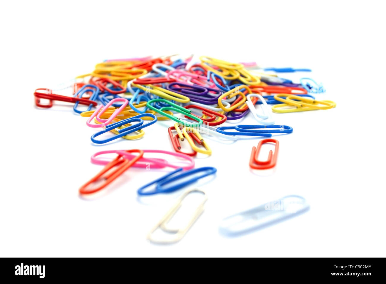Colorful paper clips on white background Stock Photo - Alamy