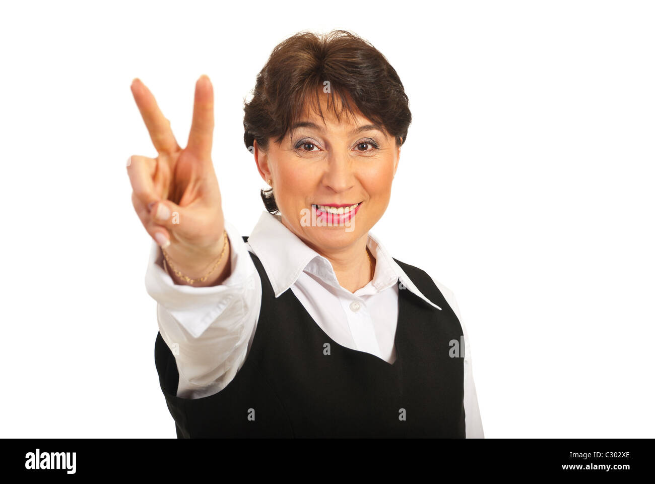 Victorious mature business woman showing victory sign hand gesture ...
