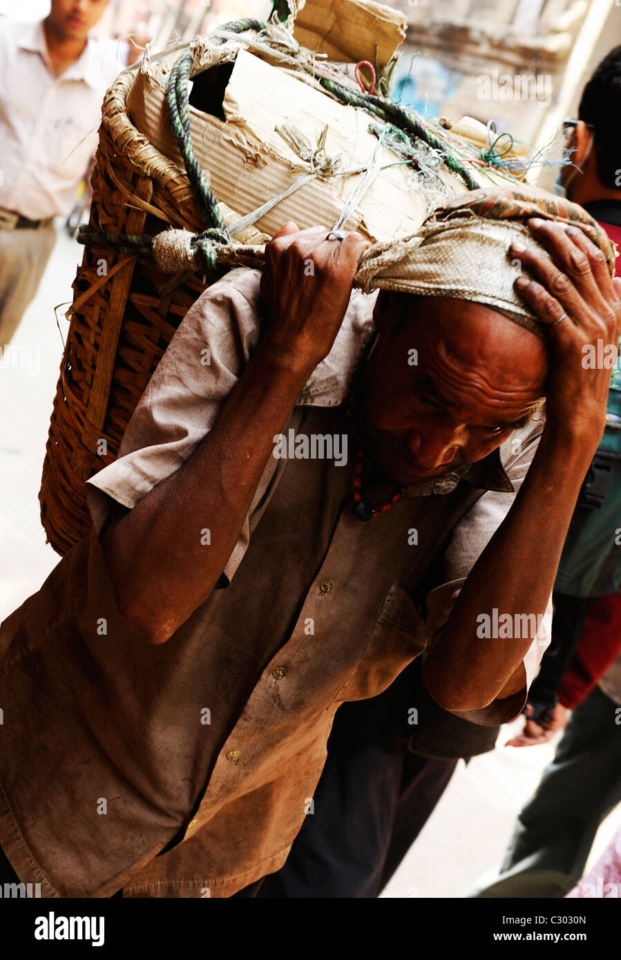 hard working sherpa carrying heavy load , street life in kathmandu ...