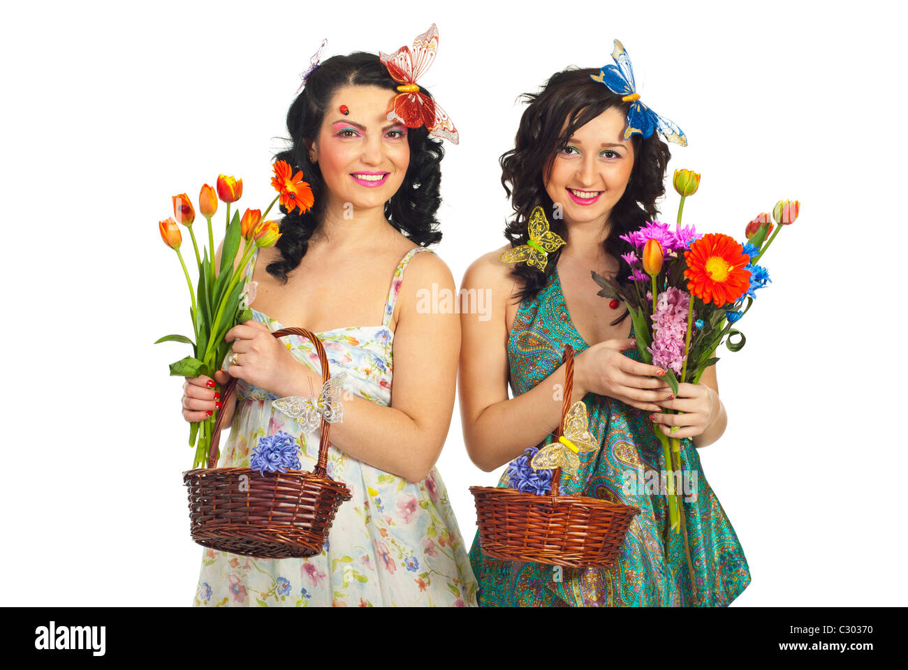 Beauty spring two women holding fresh flowers isolated on white ...