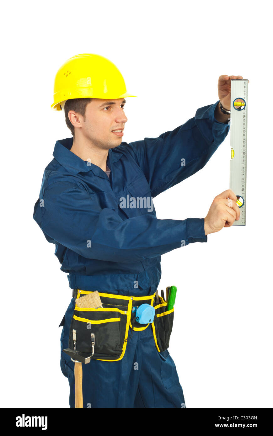 Young worker man measuring with bubble level isolated on white ...