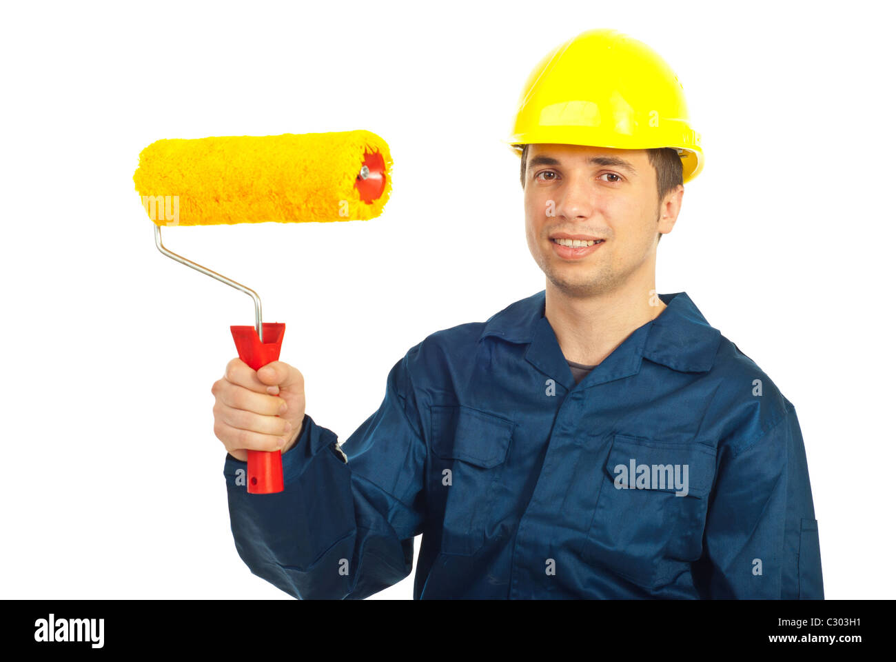 Smiling worker man with hard hat holding paint roller isolated on white ...