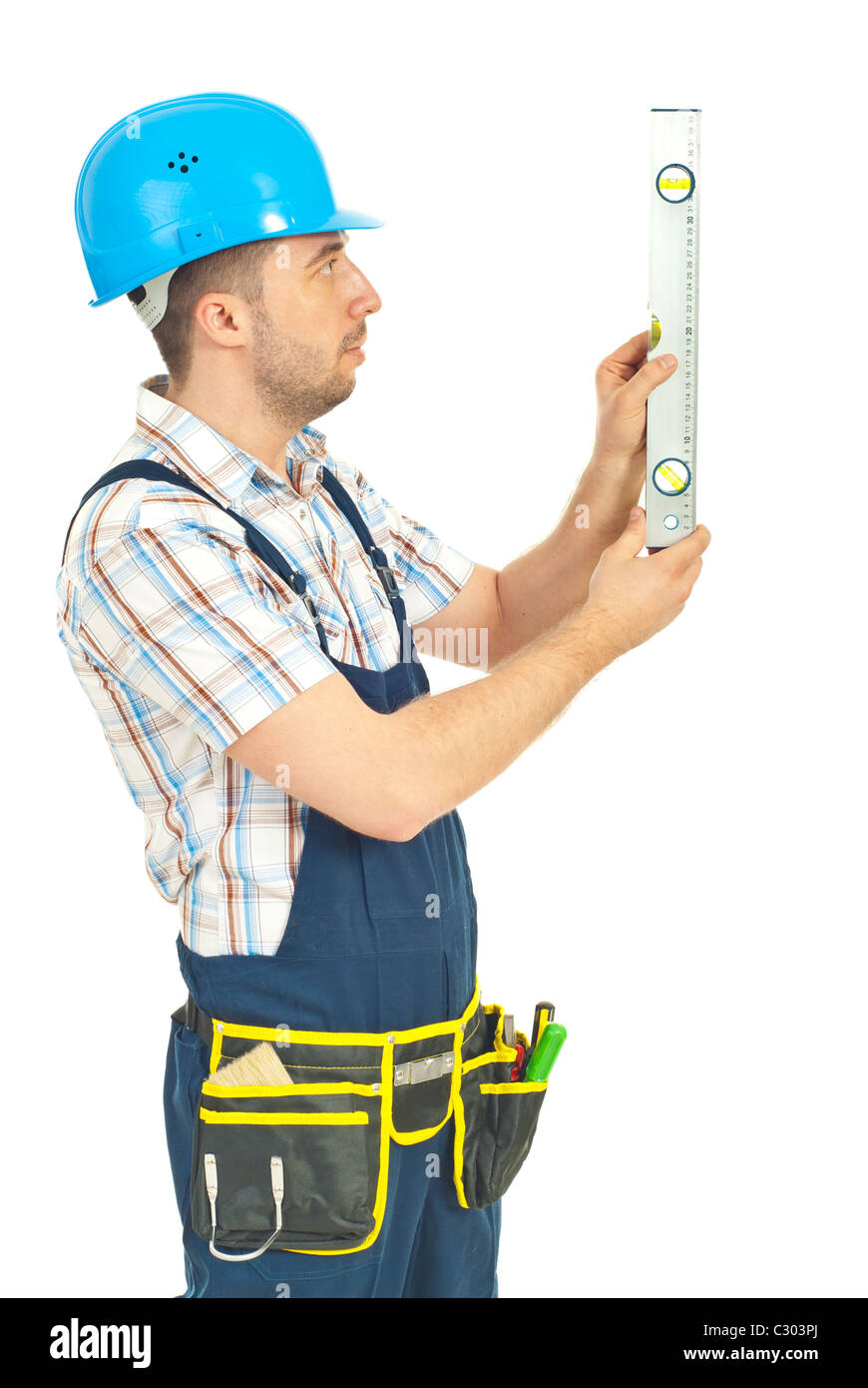 Worker man measuring with bubble level isolated on white background ...