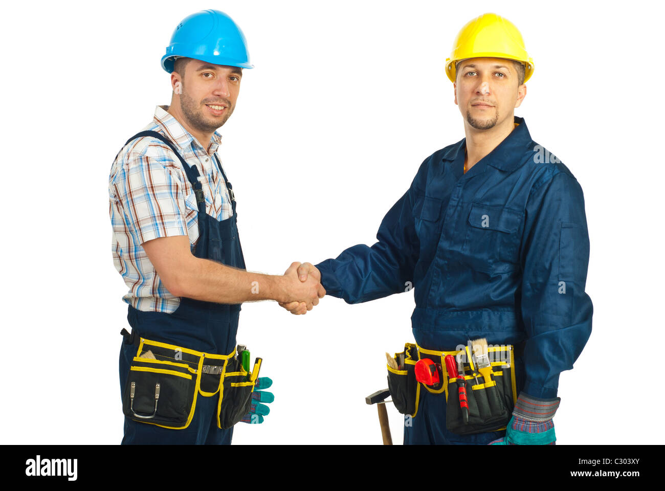 Two mid adults constructors workers giving hand shake isolated on white ...