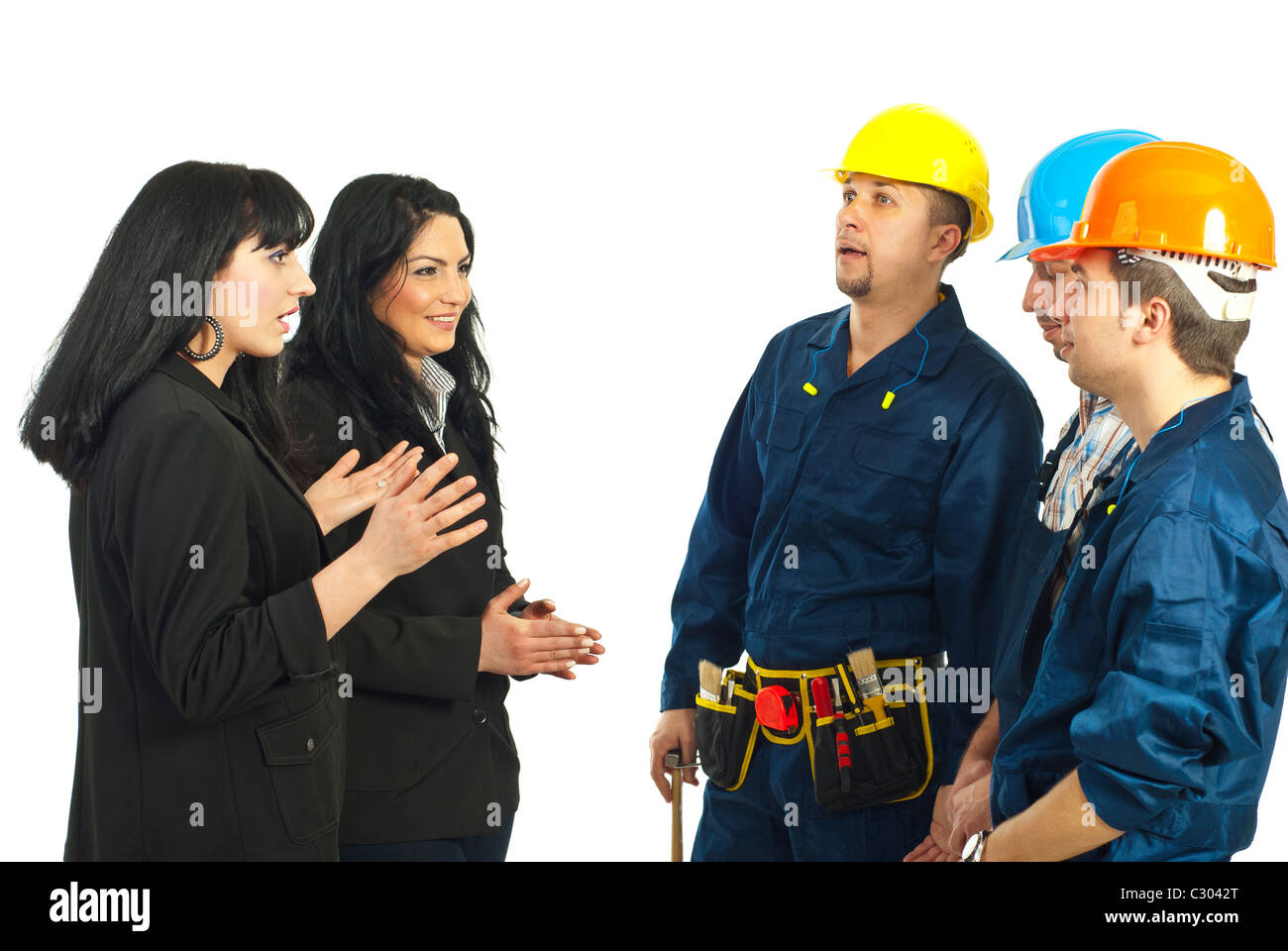 Two business women managers talking with team of constructor workers ...