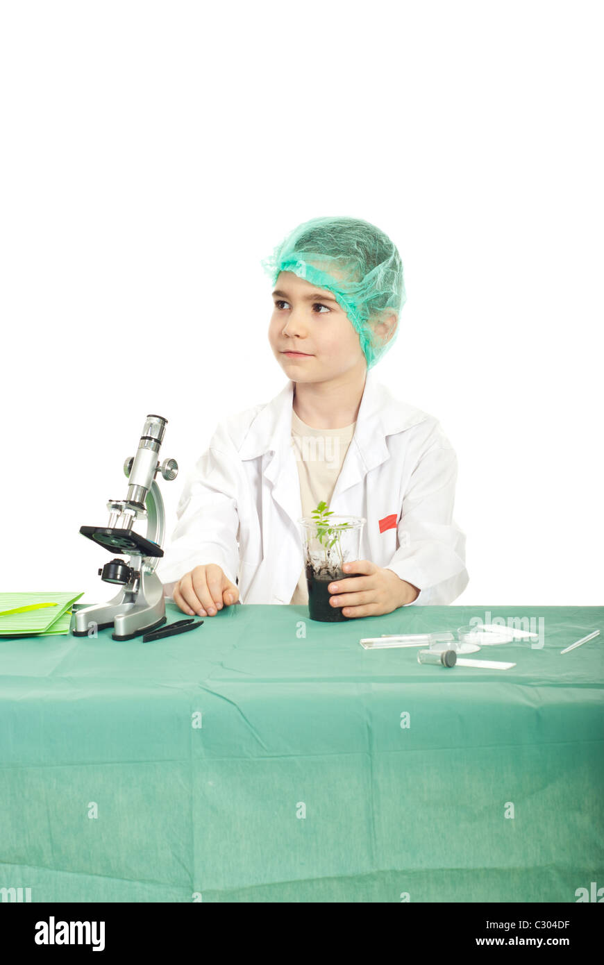 Thinking small student boy in laboratory holding plant in soil and ...