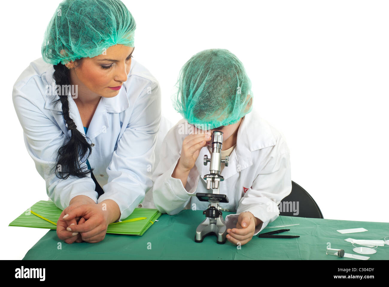 Teacher with student in laboratory looking into microscope over white ...