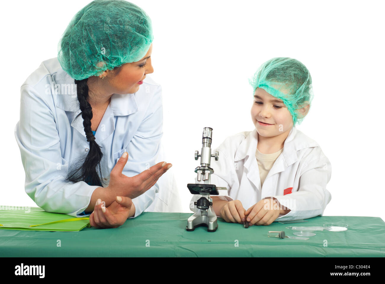Scientist teacher having conversation with little student in laboratory ...