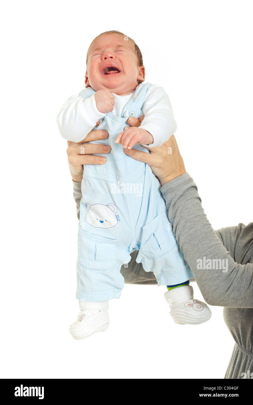 Mother hands holding crying newborn baby against white background Stock ...
