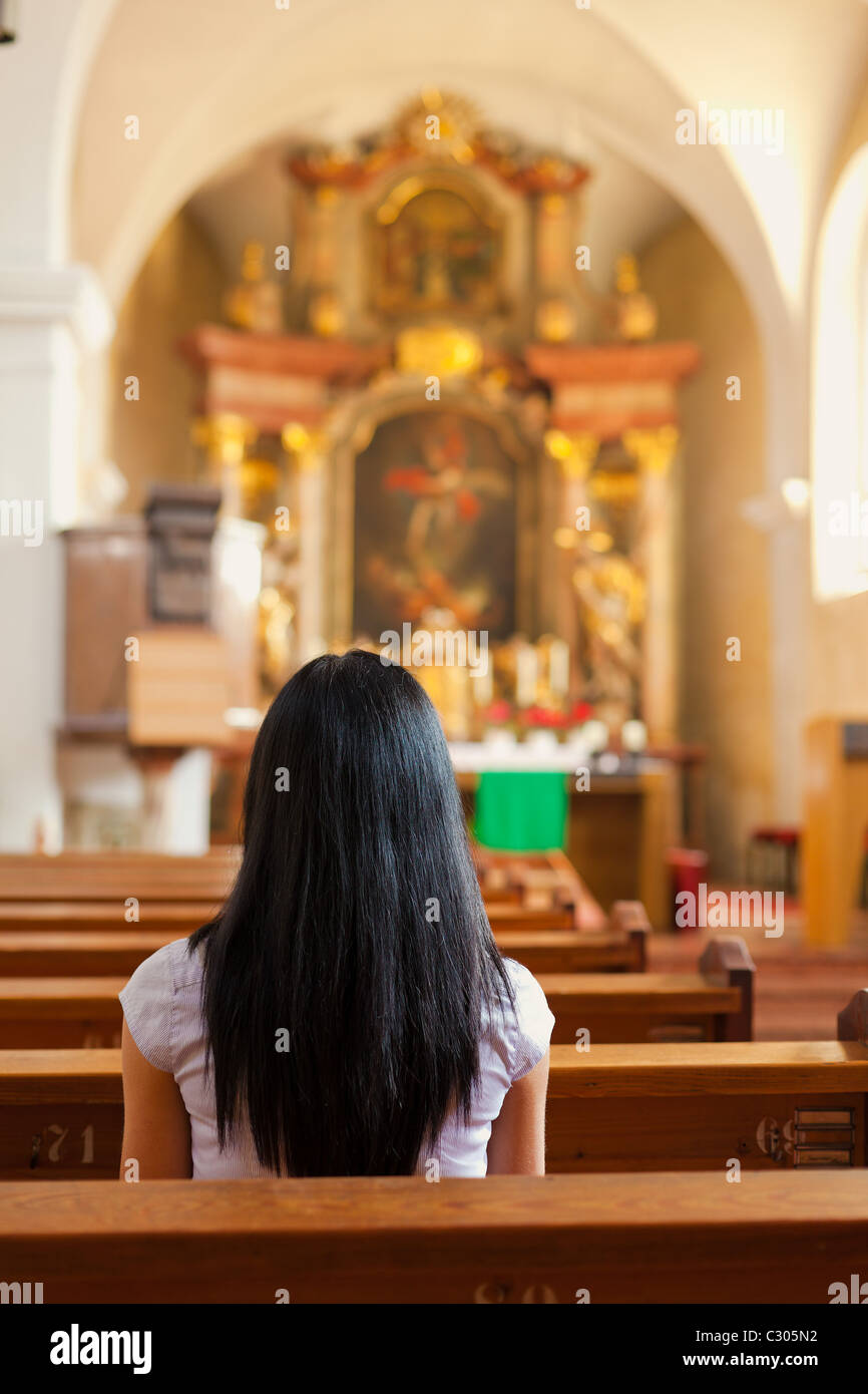 Woman prays in a church Stock Photo - Alamy