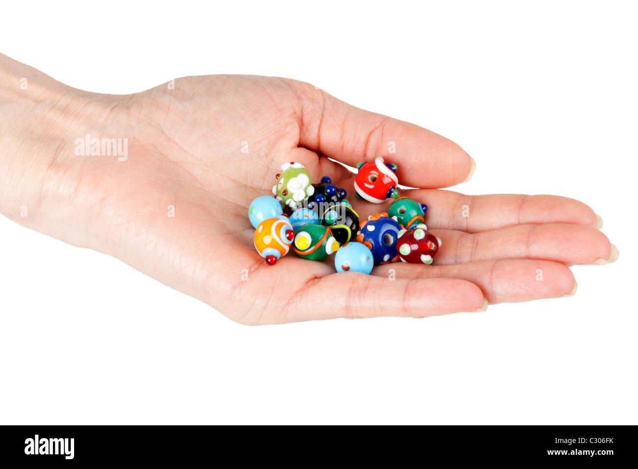 Colored glass beads in a female hand on a white background Stock Photo ...