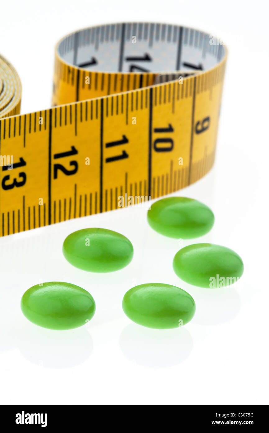 Measuring tape with tablets Stock Photo - Alamy