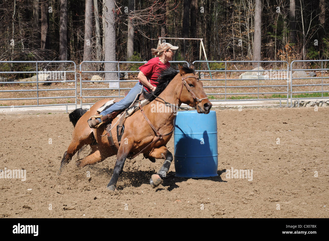 Young blond woman barrel racing Stock Photo - Alamy