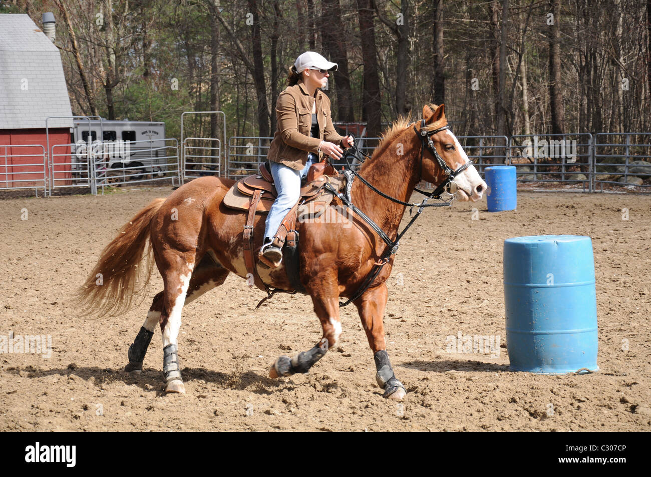 Young woman practicing barrel racing Stock Photo - Alamy