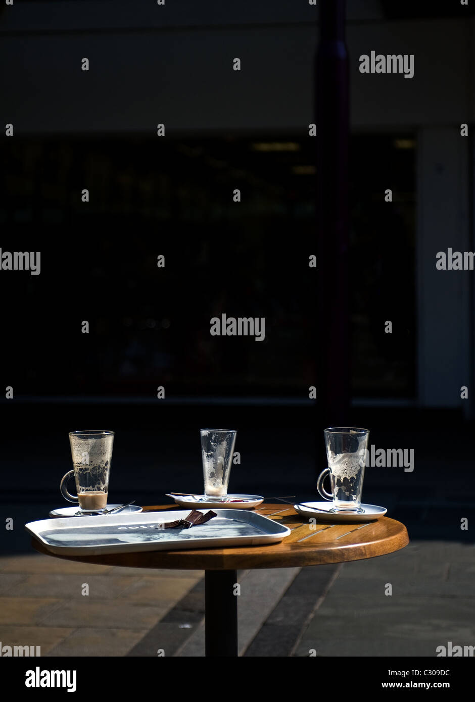 A table with empty coffee cups Stock Photo - Alamy
