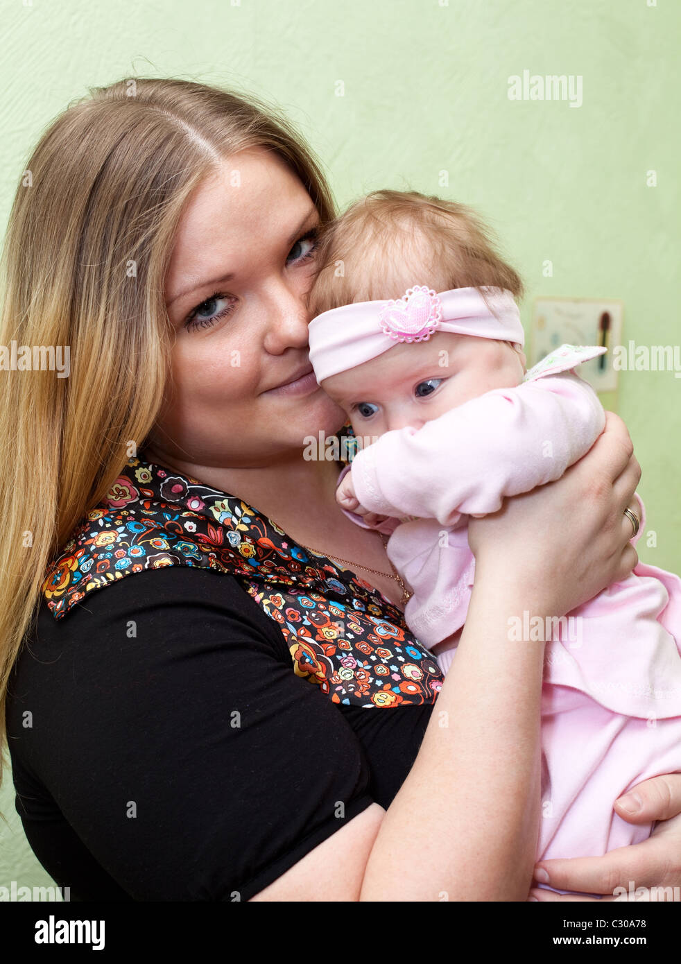 Young mother and her baby in pink clothes. Russian people Stock Photo ...