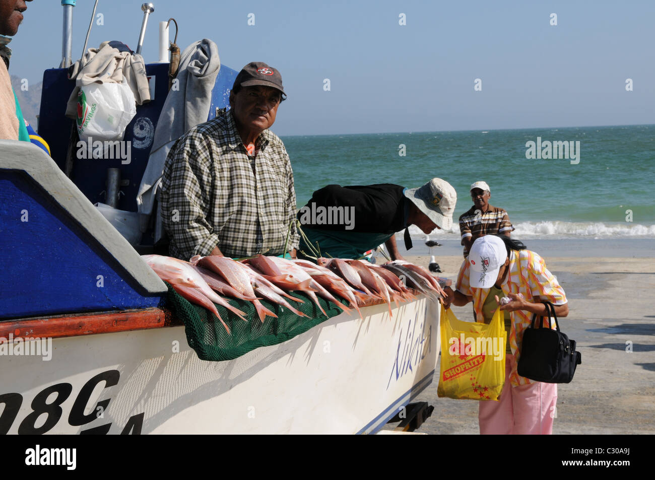 Several fishermen, fishermen who sell fish, fish for sale, boat ...