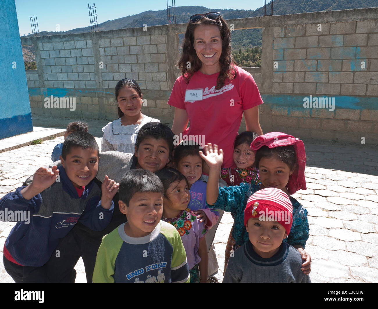 A group of primary school children in Guatemala stand with a Habitat ...