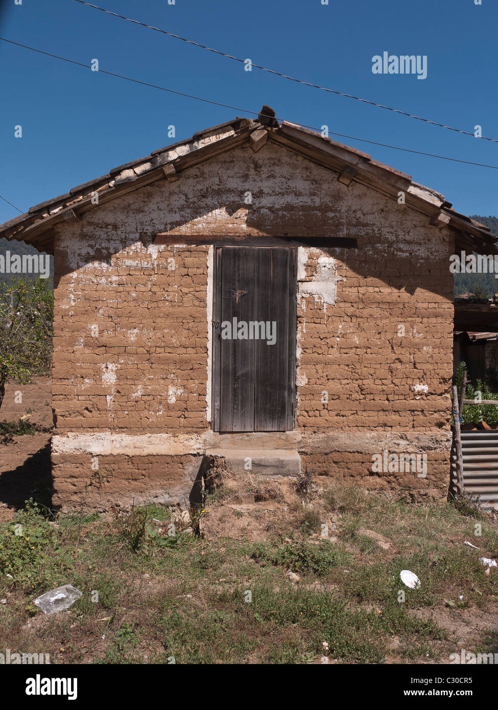 An old adobe building,built in traditional manner, in a field near ...