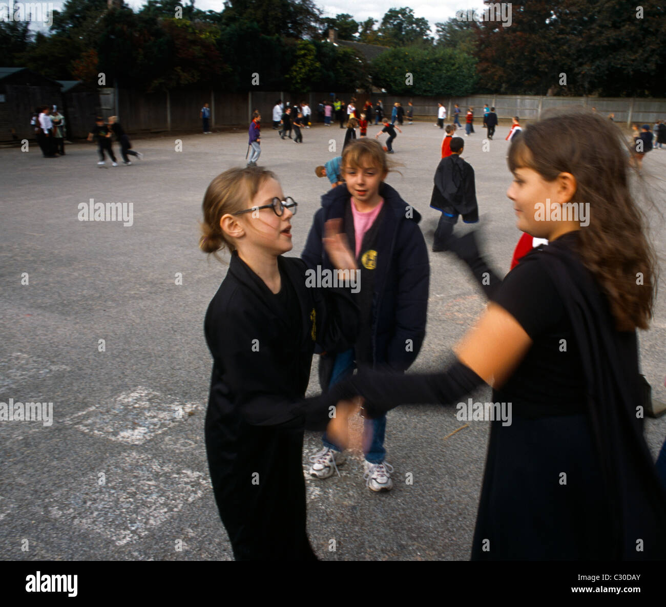 School Children Dressed For Book Day Playing A Clapping Game In The ...