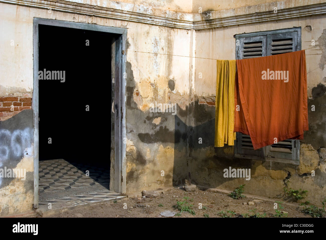 Orange Buddhist monk's robes are hanging on a clothesline at a ...