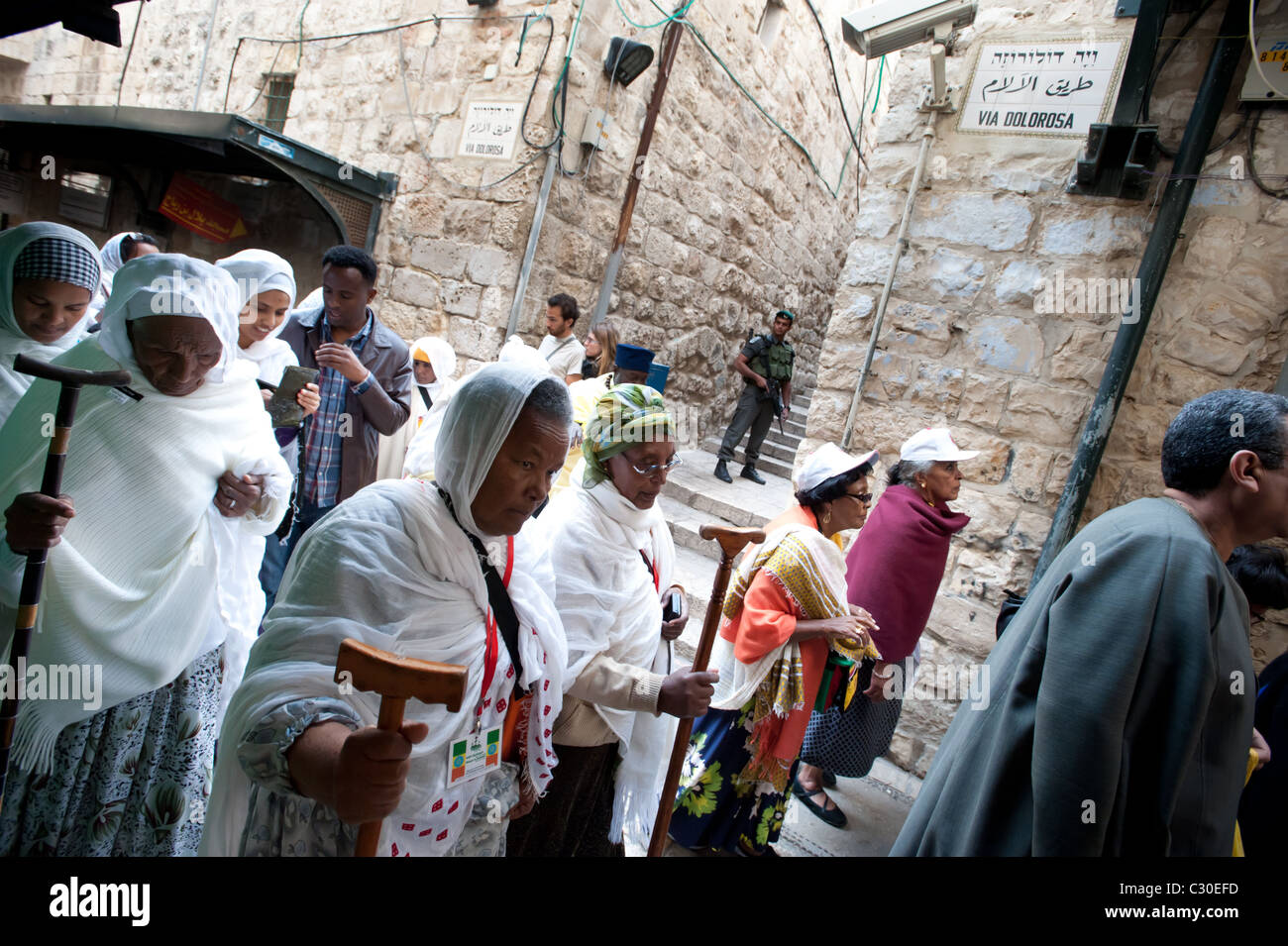 Ethiopian Christian pilgrims carry crosses along the Via Dolorosa ...