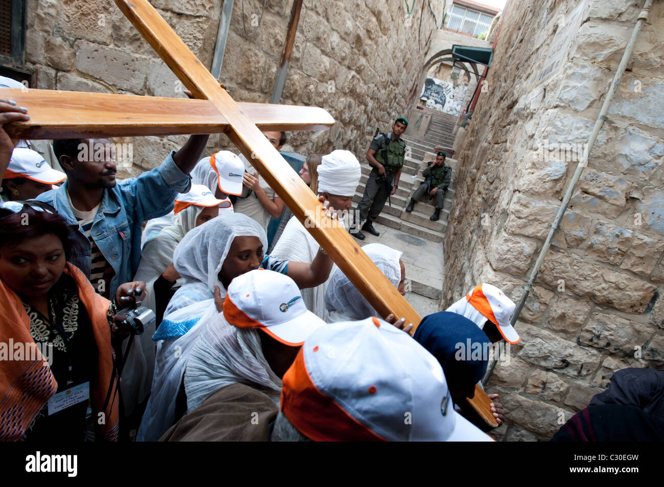 Ethiopian Christian pilgrims carry crosses along the Via Dolorosa ...