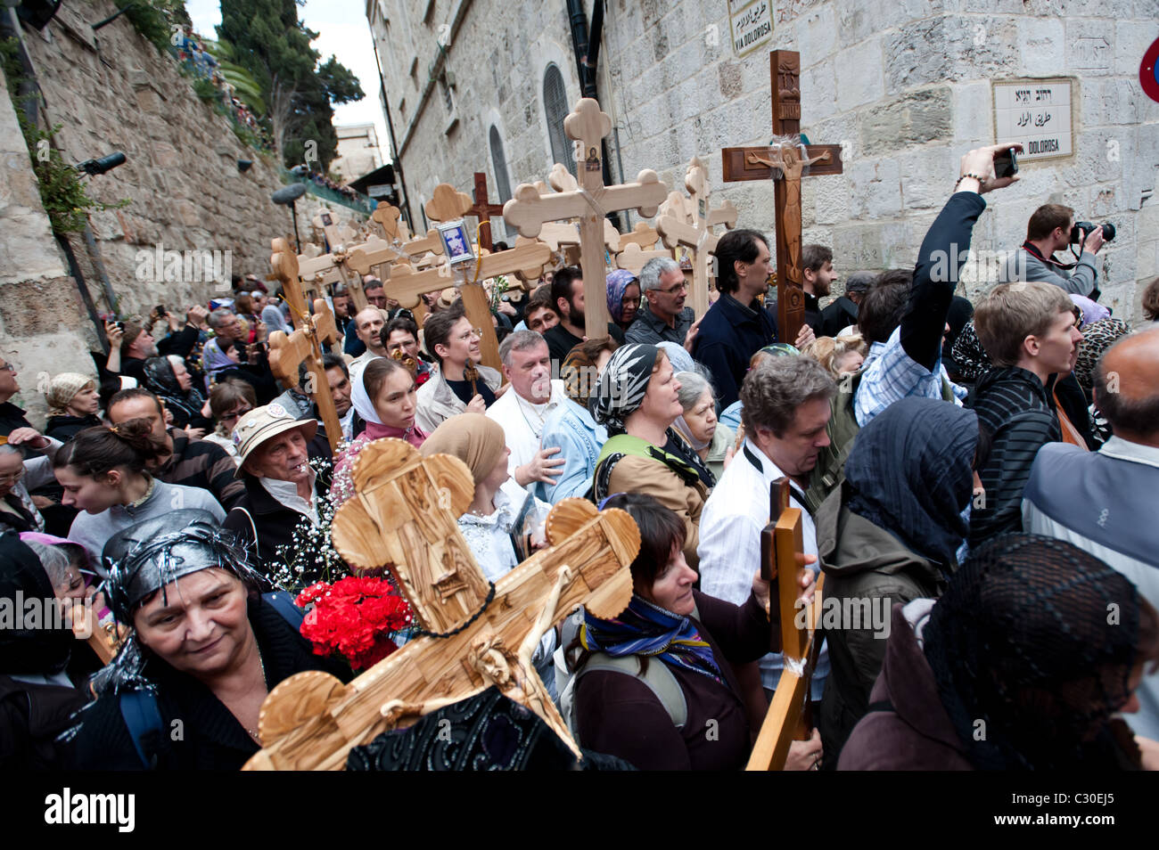 Orthodox Christian pilgrims carry crosses along the Via Dolorosa ...