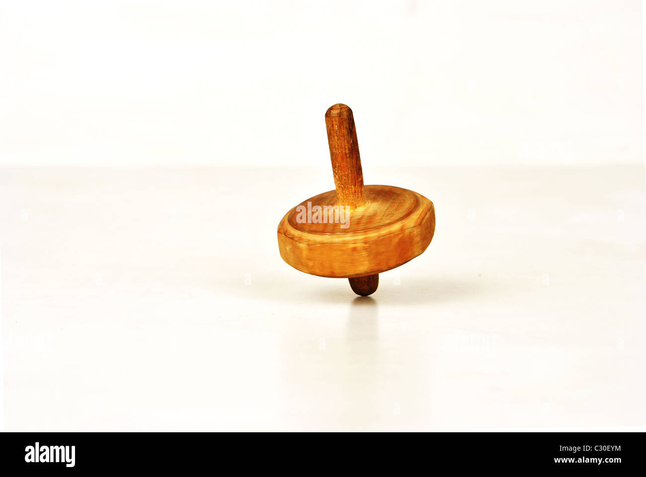 Humming or spinning top in motion on white background Stock Photo - Alamy