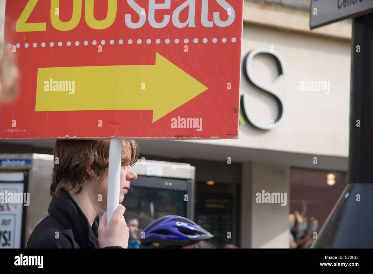 Young man holding and advertising sign; Bath, UK Stock Photo - Alamy