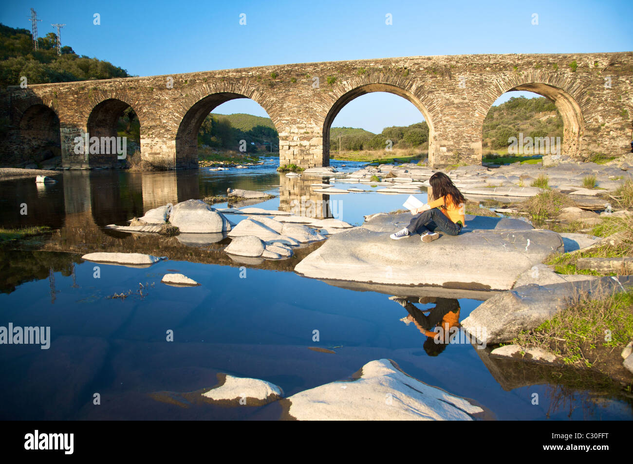 ancient stone bridge on a river in salamanca spain Stock Photo - Alamy