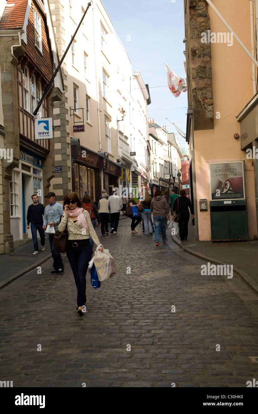 Pedestrians walk shopping street St Peter Port Guernsey Channel Islands ...