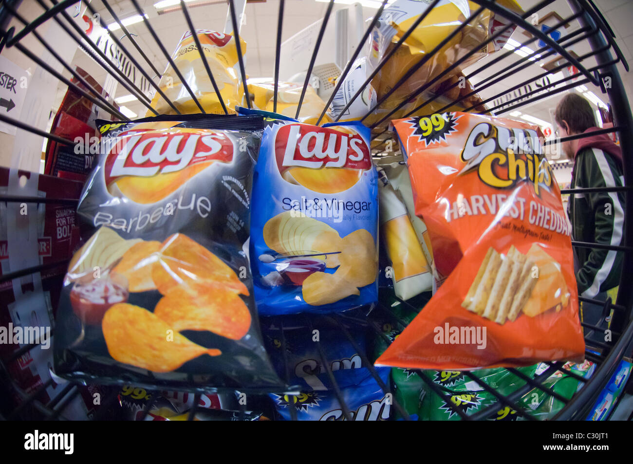 A display of tasty Frito-Lay brand chips and snacks in a supermarket in ...