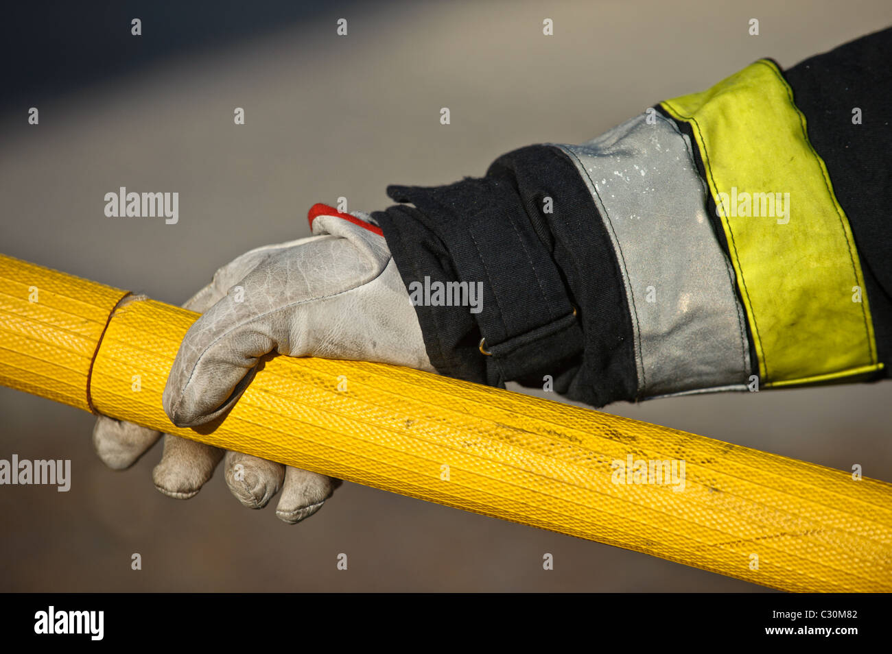 Fireman holding hose hi-res stock photography and images - Alamy