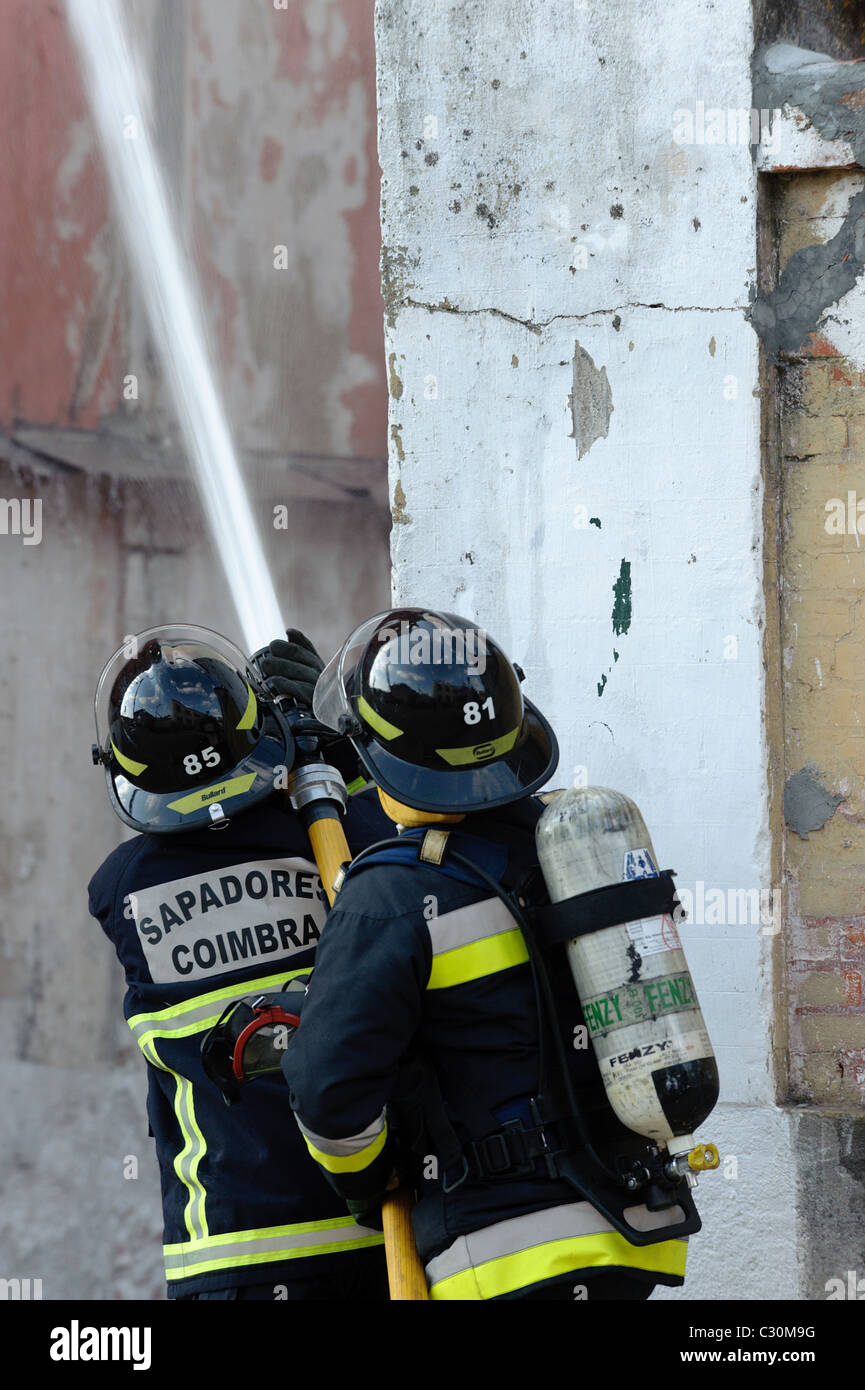 Firemen fighting urban fire Stock Photo - Alamy