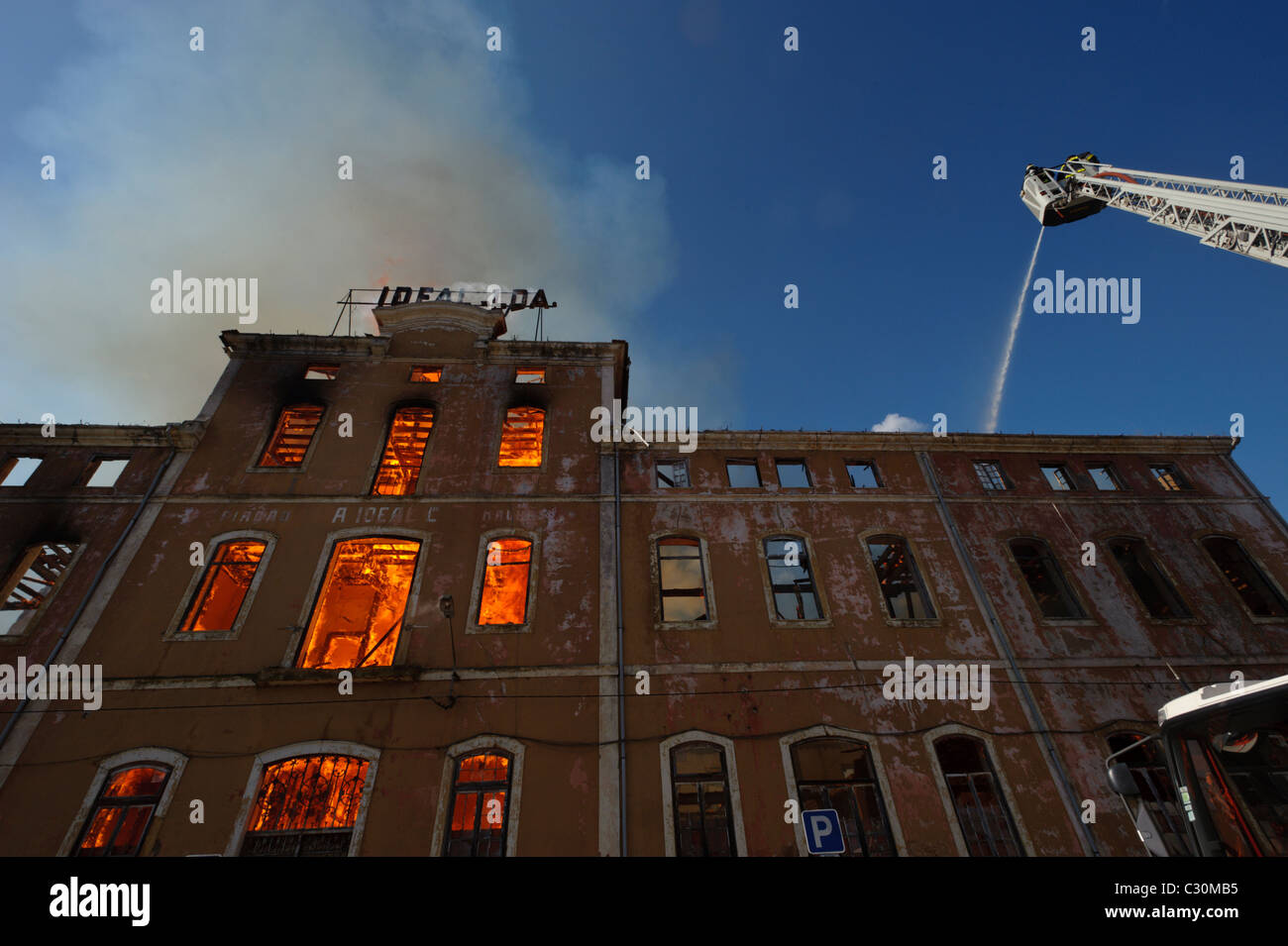 Firemen fighting urban fire with telescopic ladder Stock Photo - Alamy