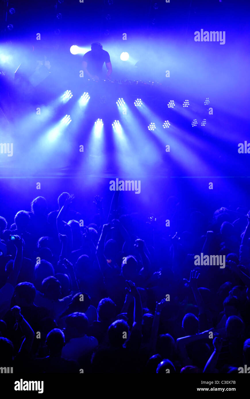 DJ and crowd at dance party, disco or rave Stock Photo - Alamy