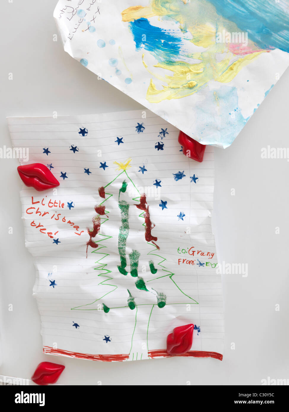 Childrens Drawing Held Up By Magnets On A Fridge Stock Photo - Alamy