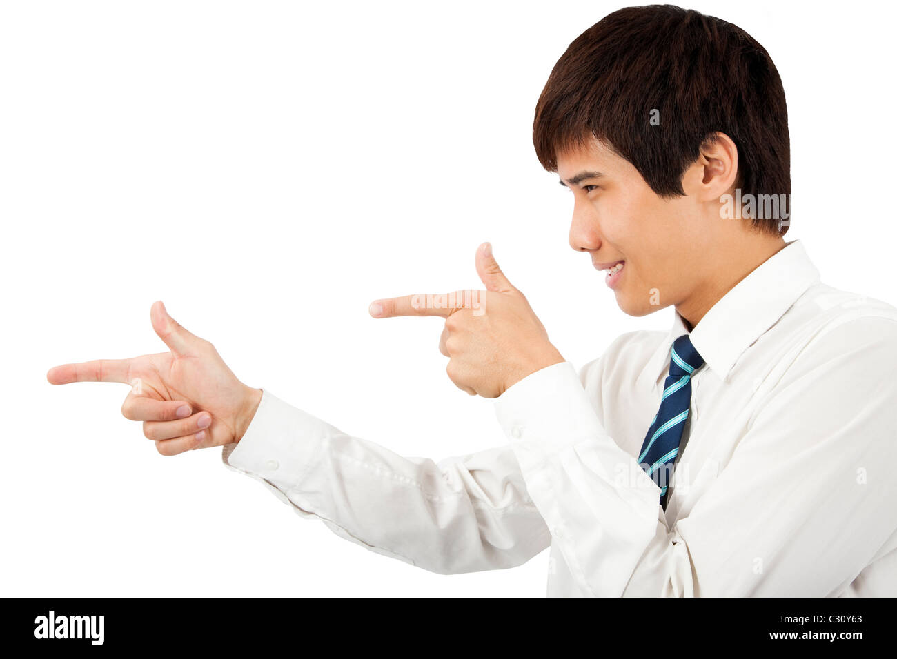 Portrait of an smiling young business man pointing at against white ...