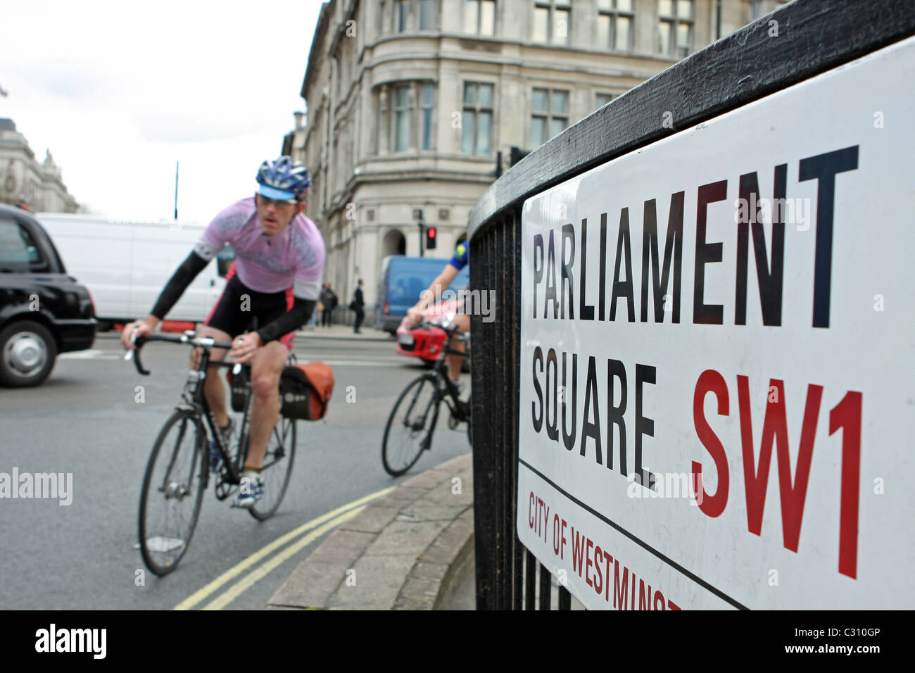A cyclist riding around a corner passed a 'Parliament Square' street ...
