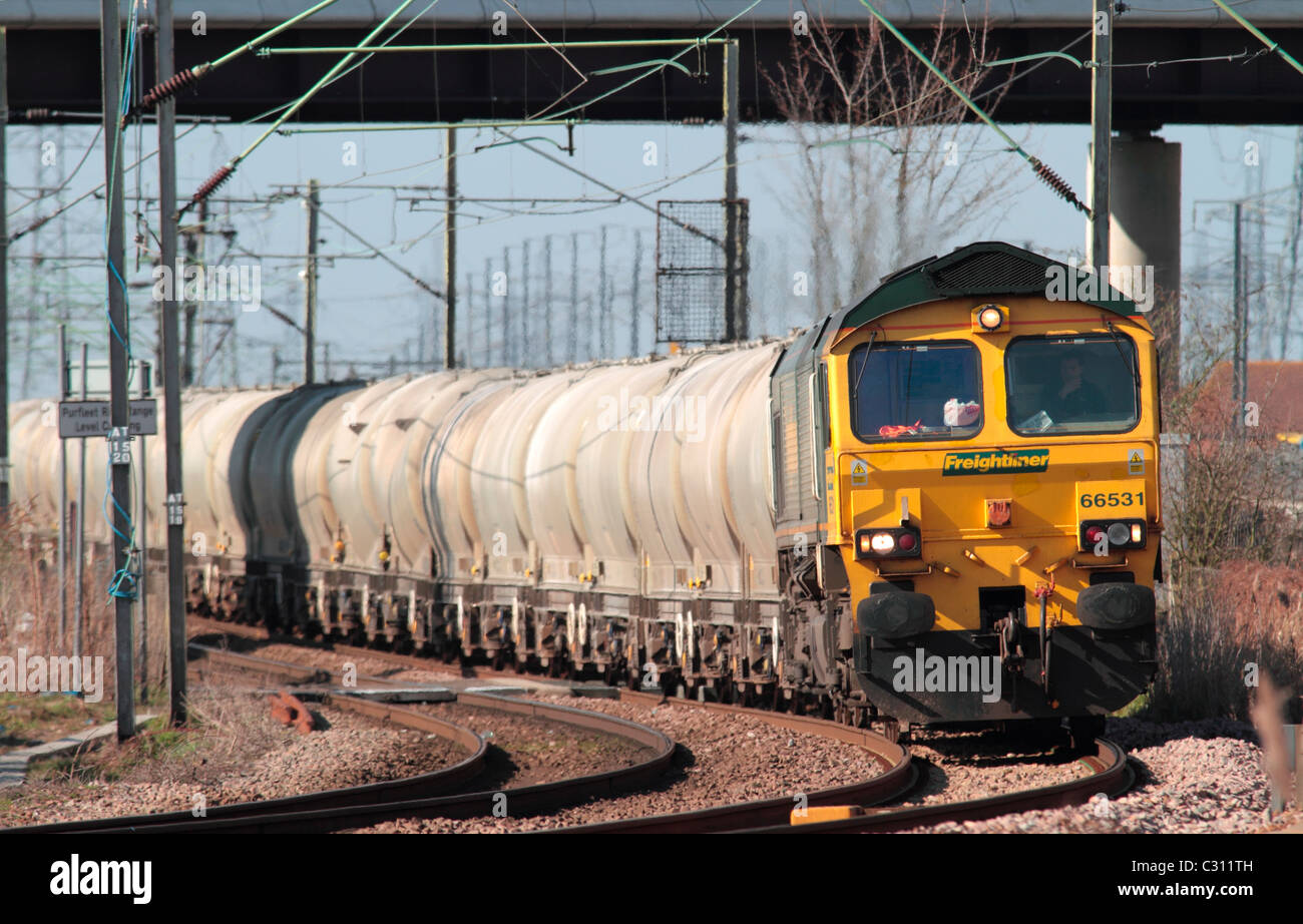 A freightliner class 66 locomotive working a cement train near Purfleet ...