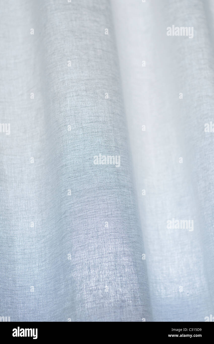 White cotton curtains with daylight filtering through on a Spring day ...